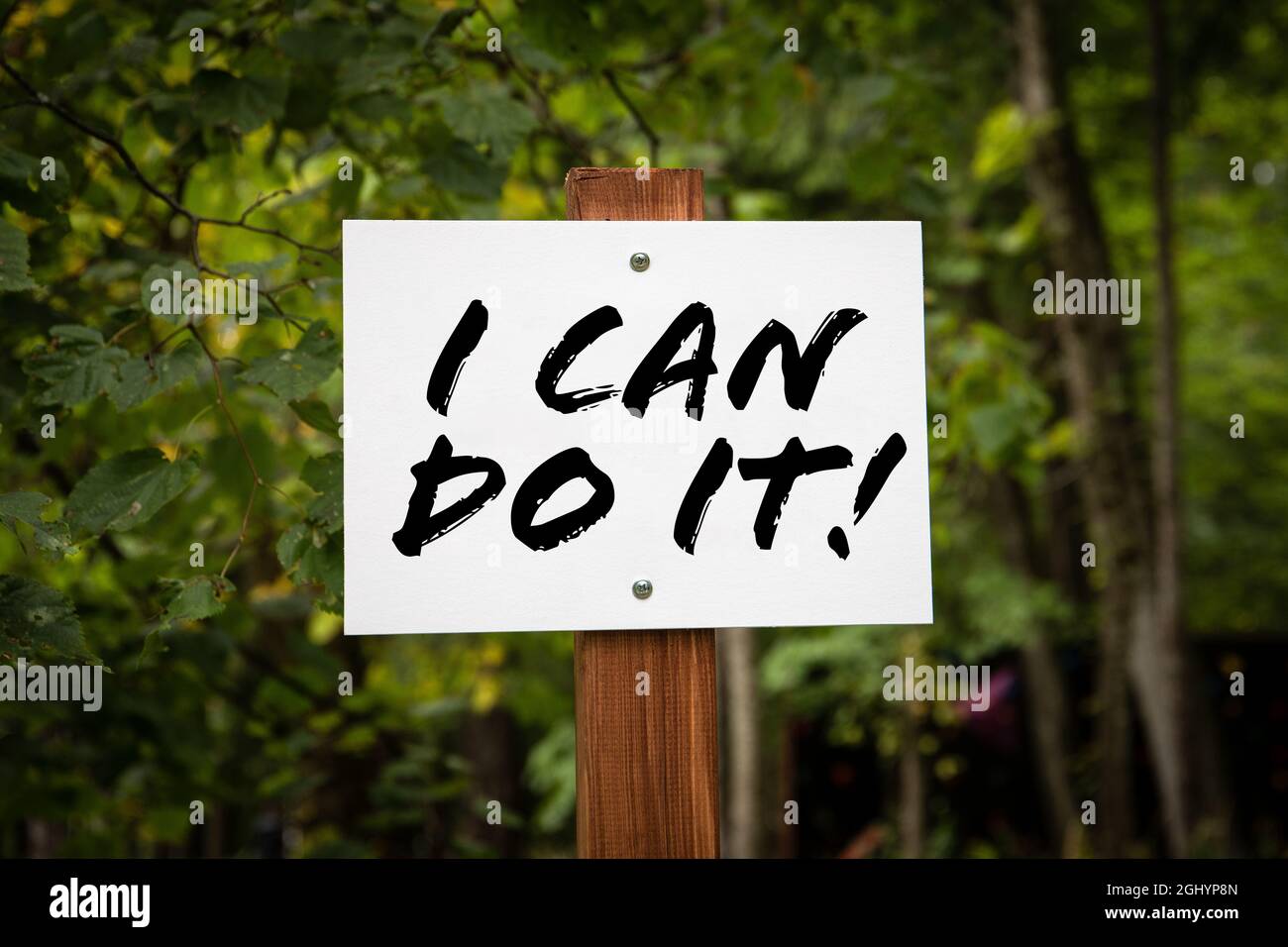I can do it. White information board on a green tree background Stock ...