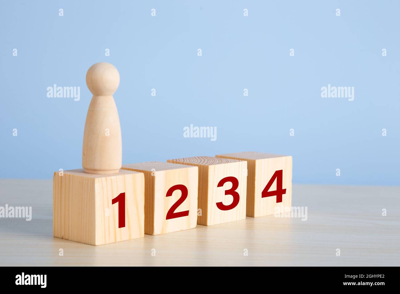Wooden figure standing on the wooden block. Concept of business ...