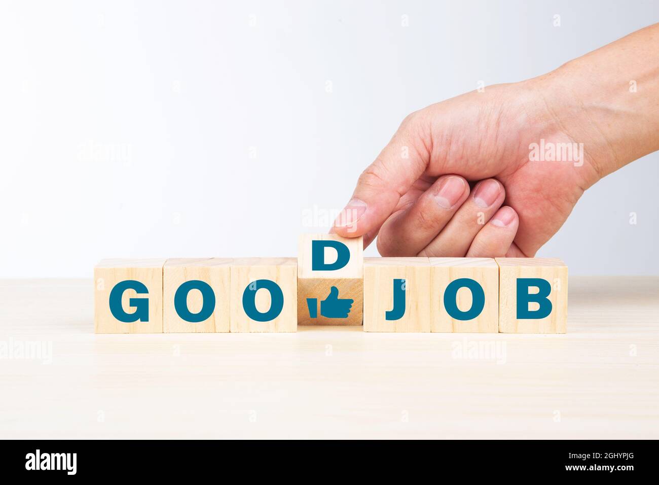 Wooden cube block with word good job on wood table Stock Photo - Alamy