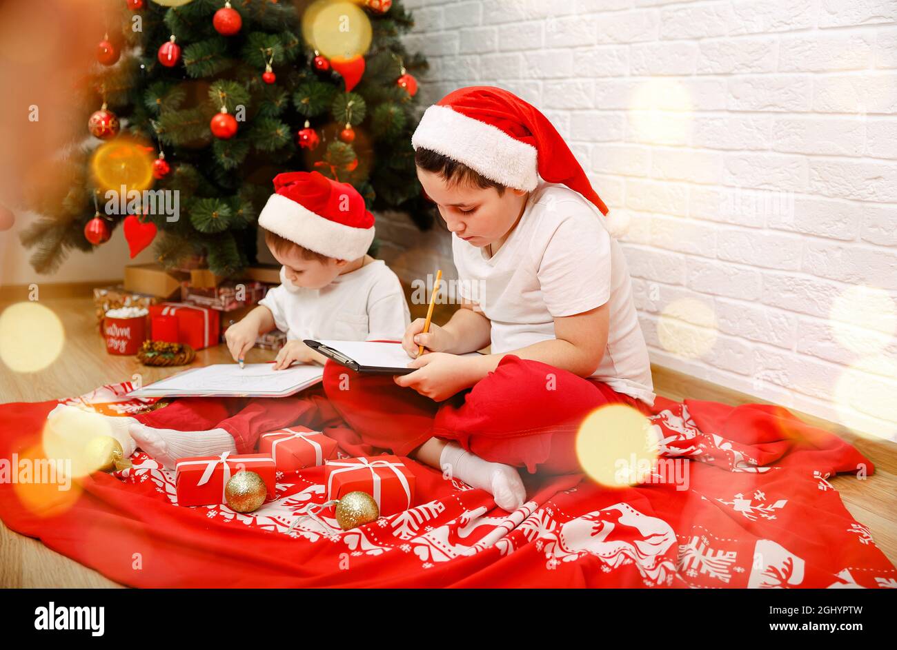 Happy children celebrating Christmas indoors . Cheerful small boys ...