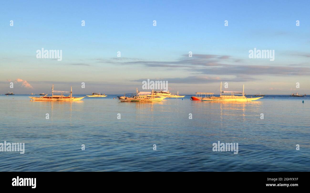Boats at sunset, Panglao Island, Bohol, Philippines Stock Photo - Alamy
