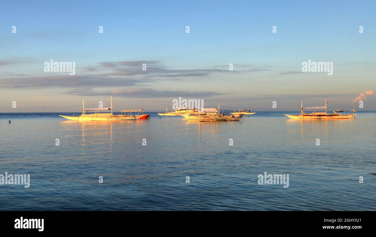 Boats at sunset, Panglao Island, Bohol, Philippines Stock Photo - Alamy