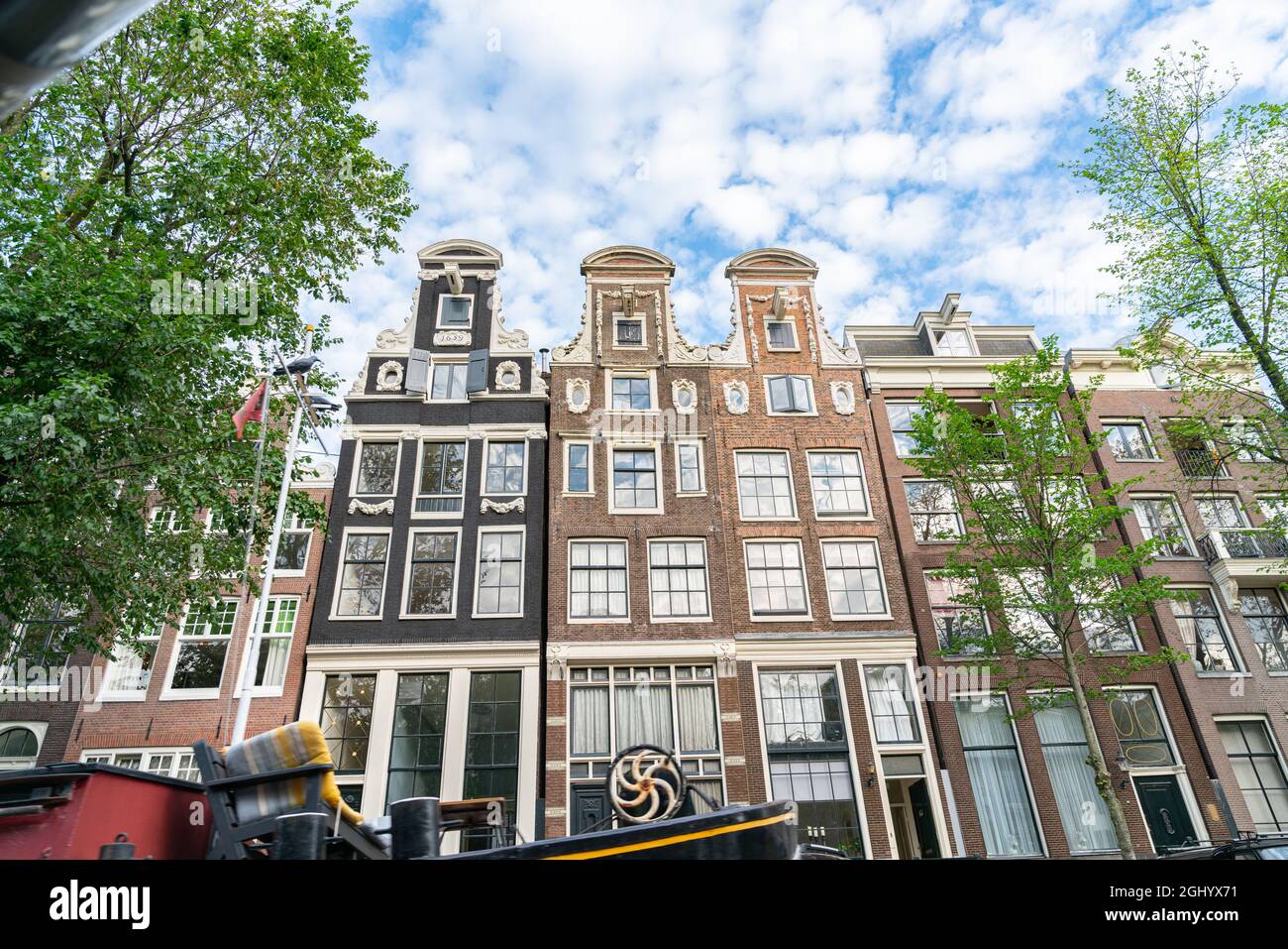 Traditional Dutch architecture with a row of tall thin buildings and ...