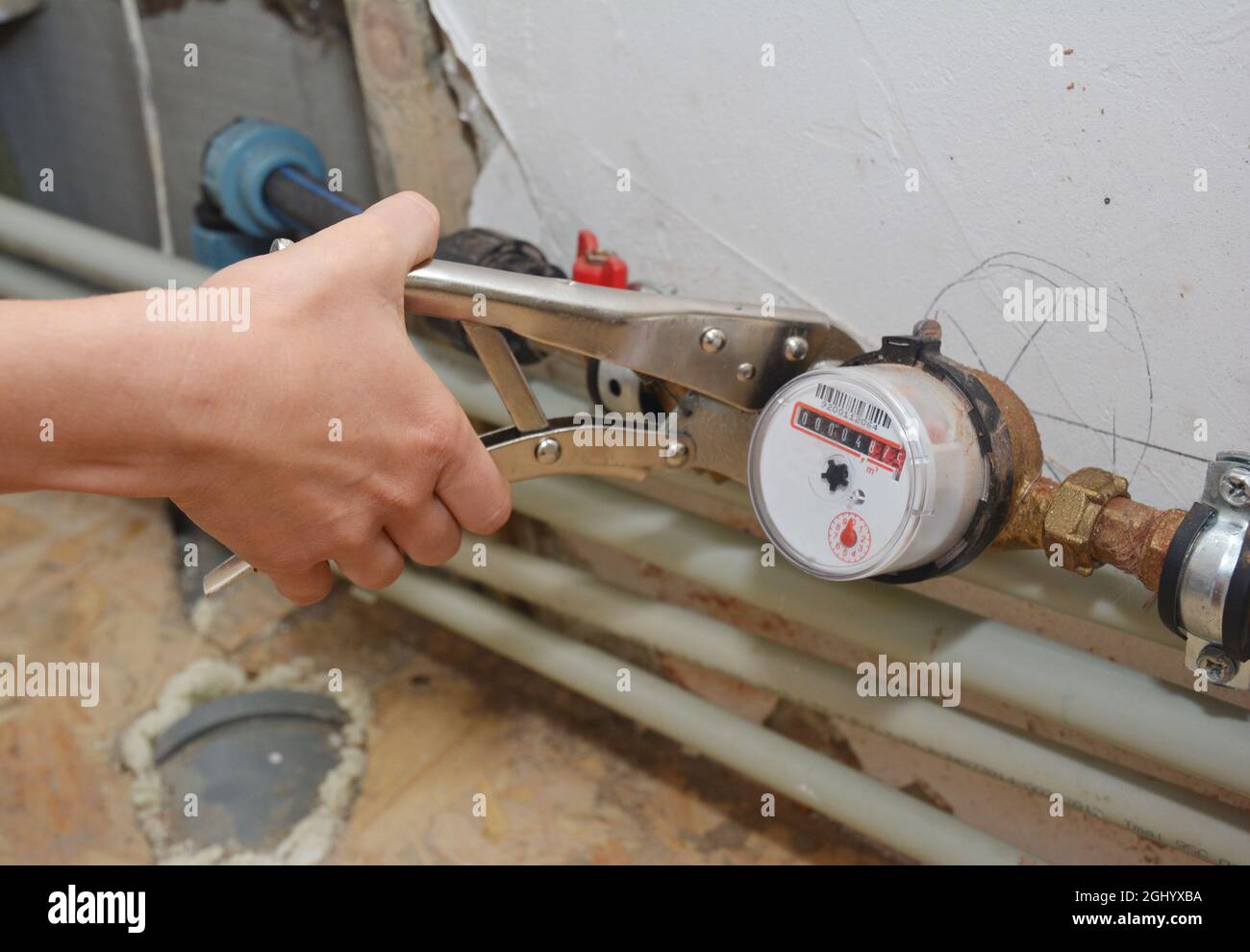 Water meter installation, replacement indoors by a plumber Stock Photo ...