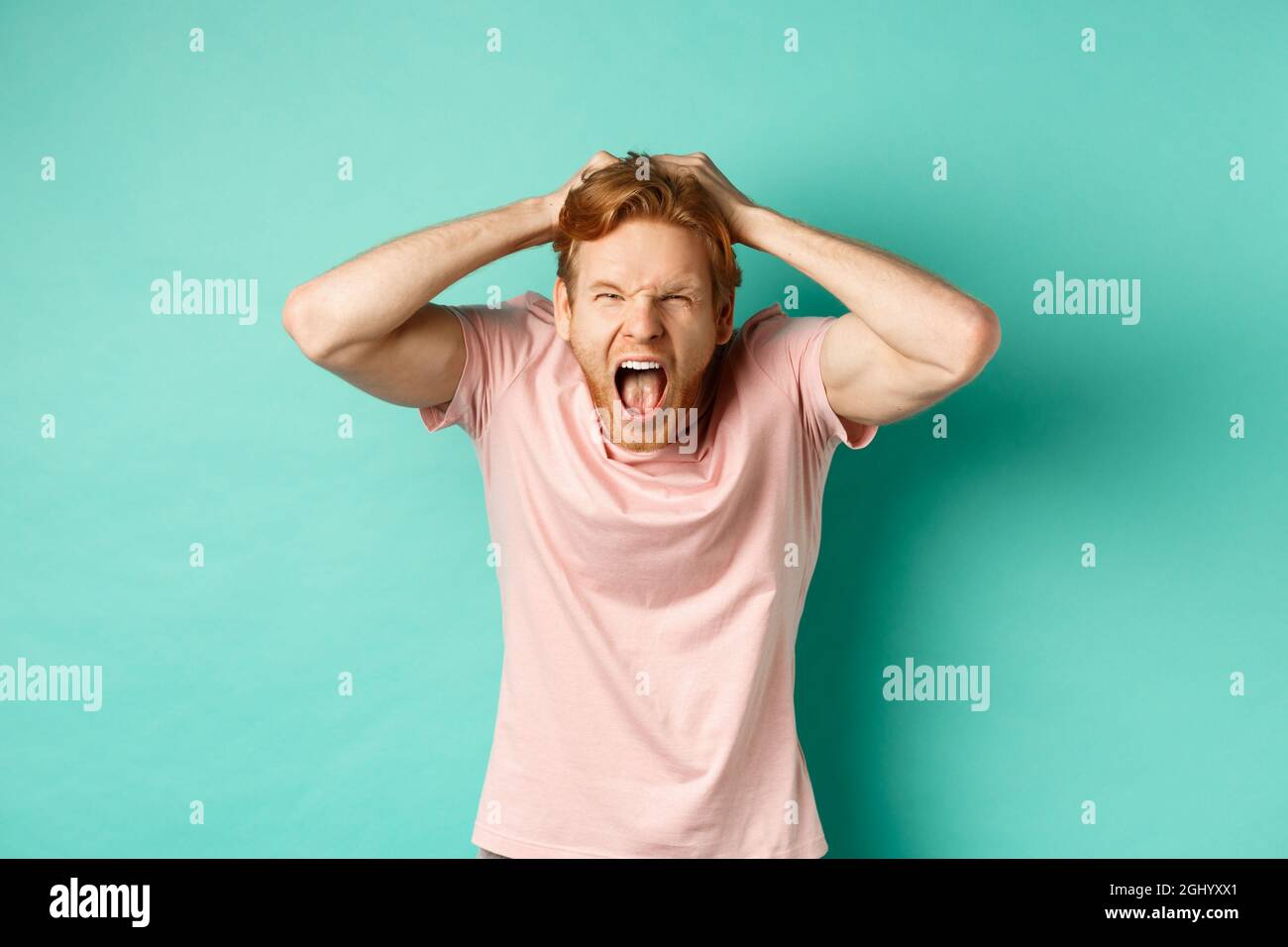 Angry redhead man screaming and ripping hair out of head, yelling and ...