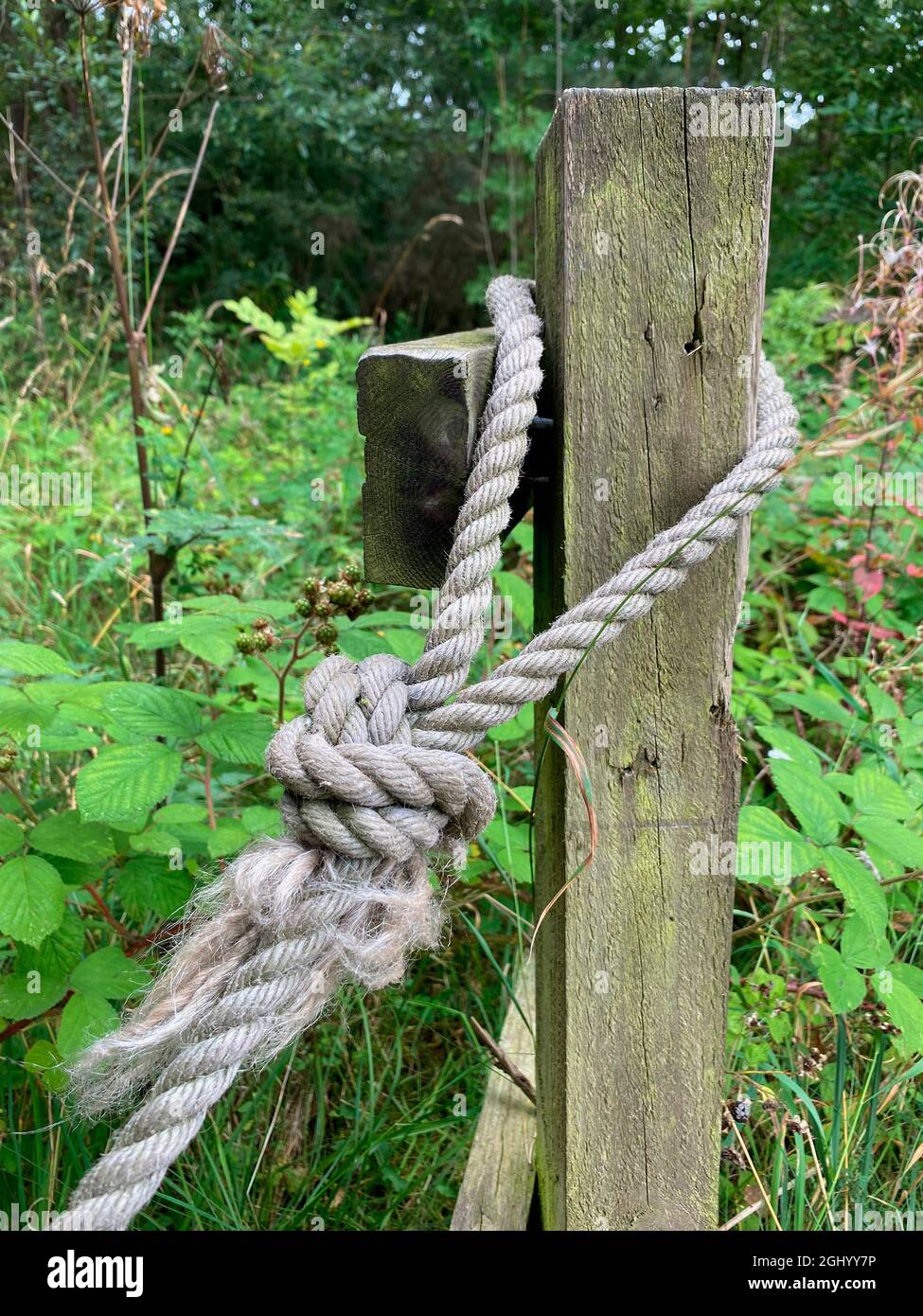 Rope around a country gatepost Stock Photo - Alamy