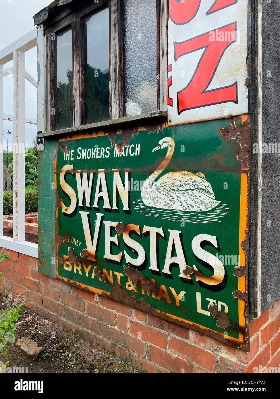 Old metal advertising signs used to line the exterior of a garden shed ...