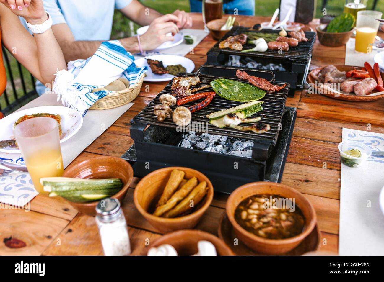 latin people eating Mexican food, Tacos, spicy salsa, tortillas, beer ...