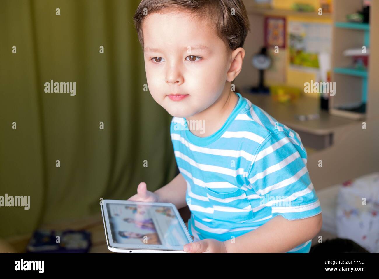 Little boy plays in the smartphone. Game on the phone Stock Photo - Alamy