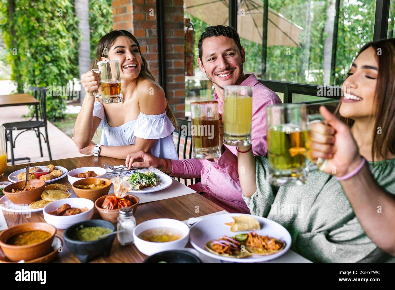Group of Young latin Friends Meeting For beer, michelada Drinks And ...