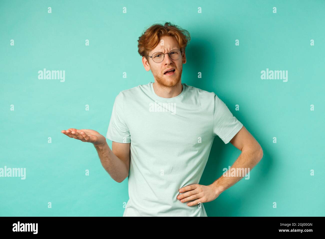 Confused redhead man trying to understand something, squinting clueless ...
