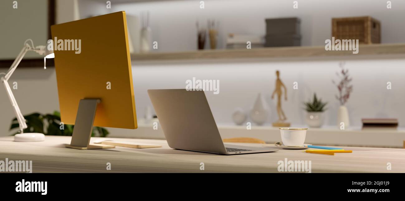 Comfortable workspace with computer and laptop, blurred room decor in ...