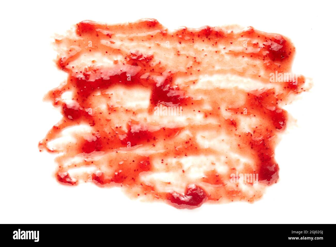 Randomly shaped thin messy smear of homemade red strawberry or ...
