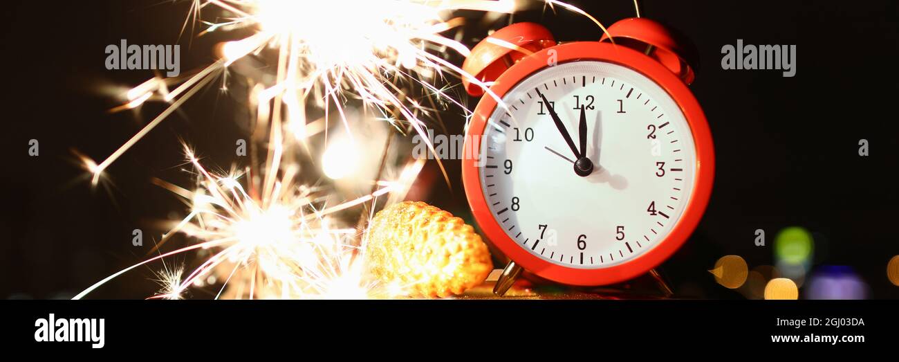 Close-up of red clock showing five before midnight Stock Photo - Alamy