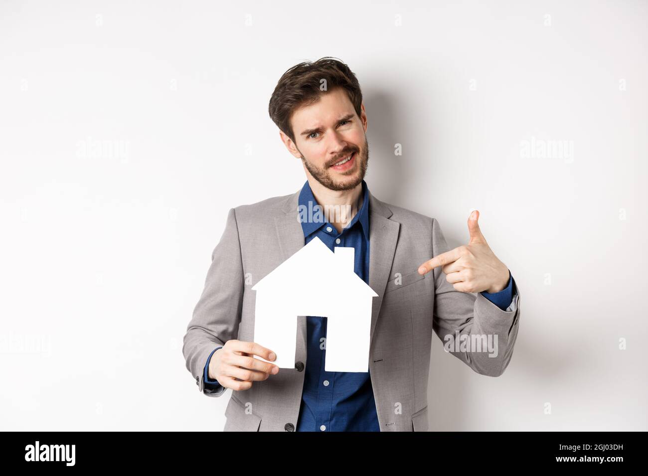 Real Estate And Insurance Concept Salesman In Grey Suit Showing Paper