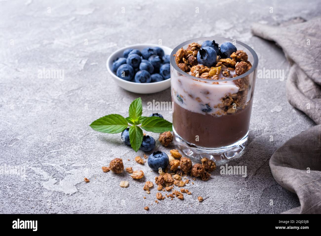 Tasty chocolate pudding or sweet mousse with yogurt, blueberry, granola ...