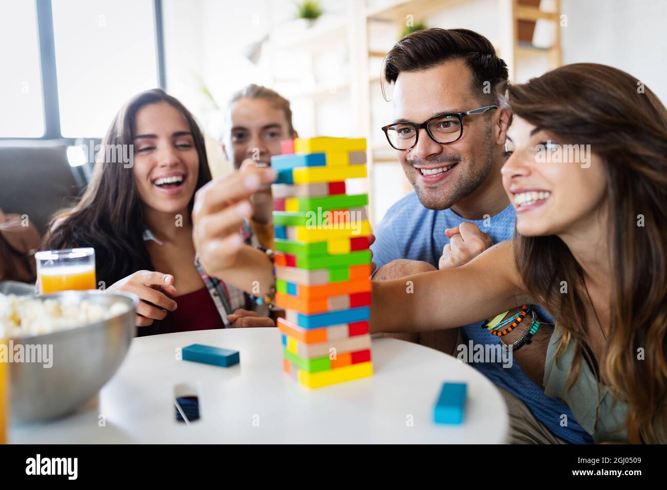 Happy group of friends have fun and playing board game together Stock ...