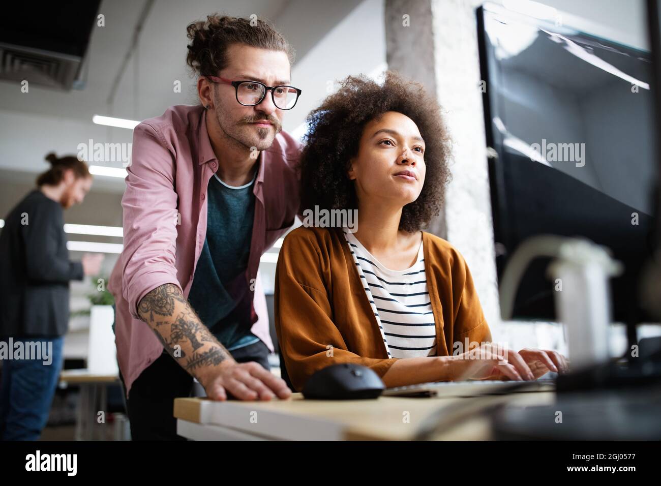 Programmers cooperating at IT company developing apps Stock Photo - Alamy