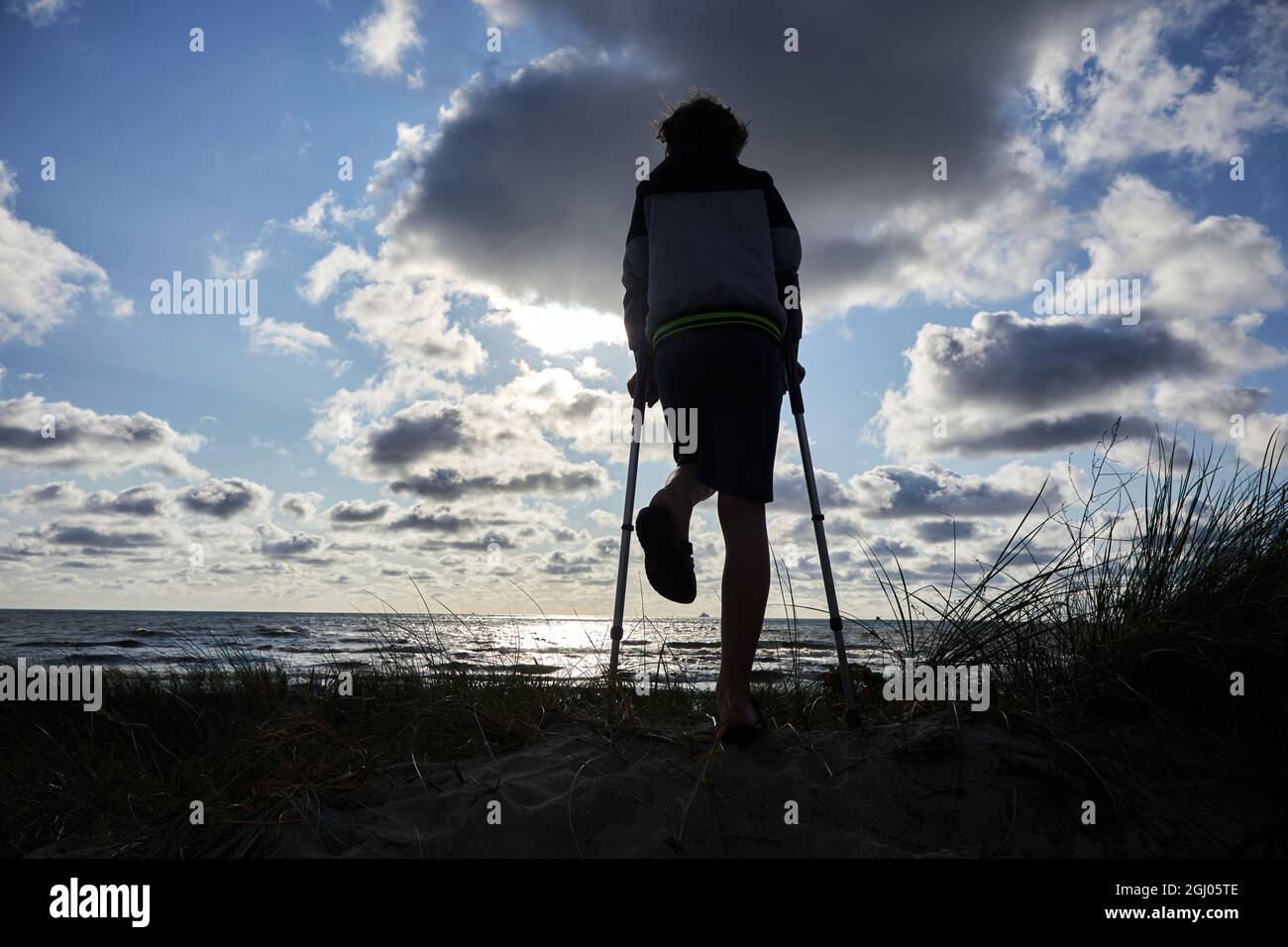 Boy crutches walk hi-res stock photography and images - Alamy
