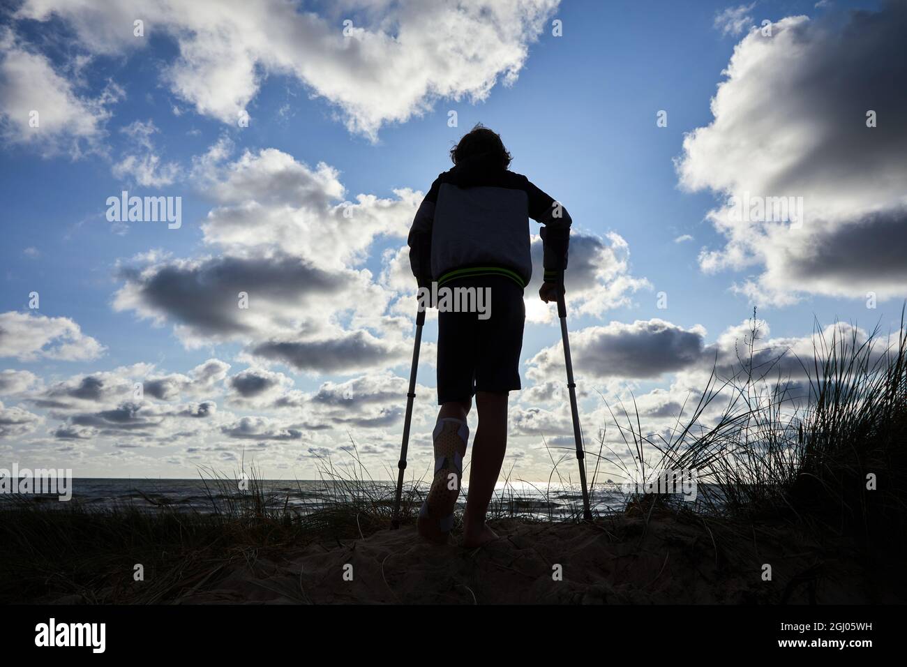 Boy crutches walk hi-res stock photography and images - Alamy