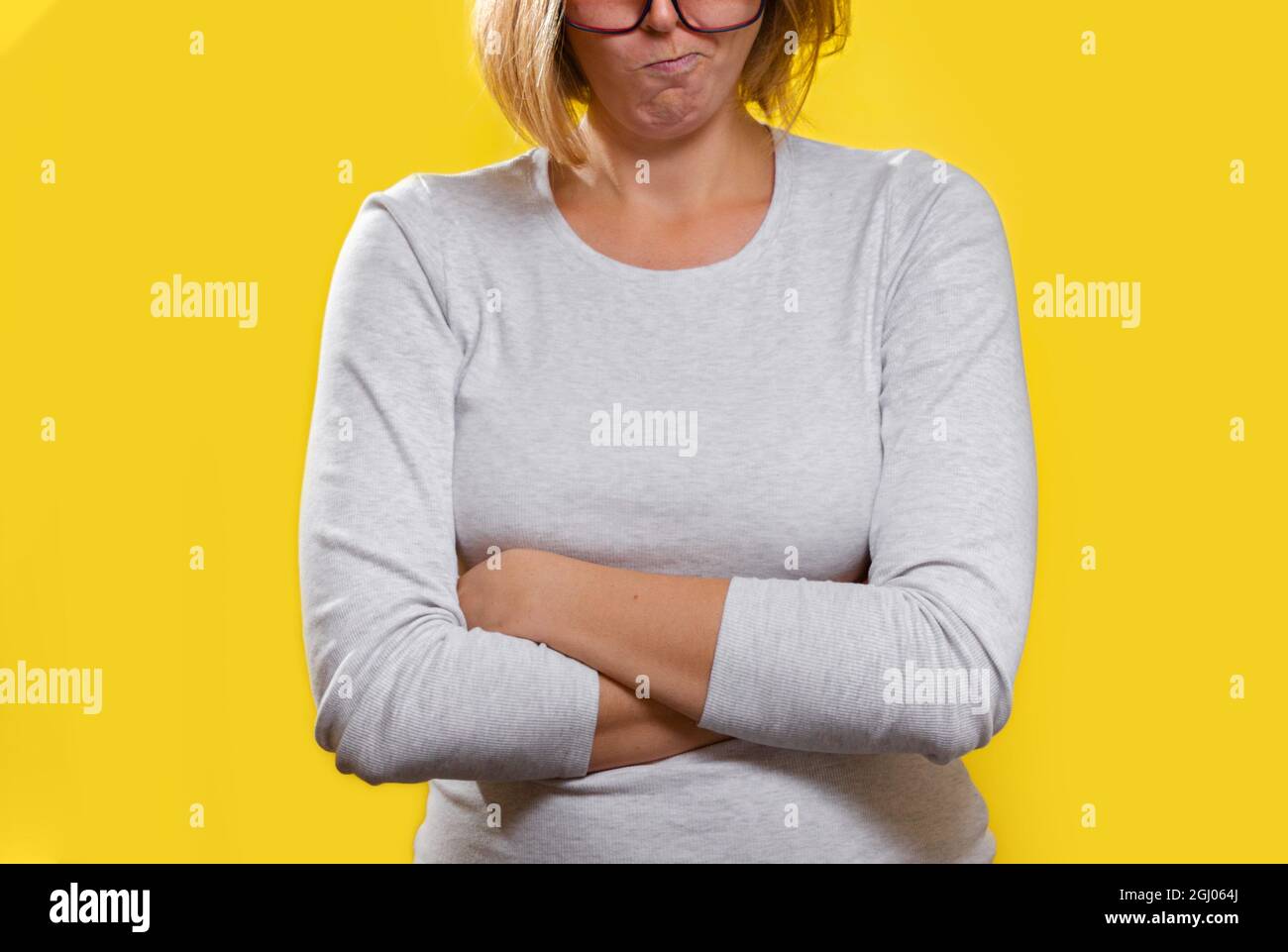 Emotions and psychology. The woman, a blonde with glasses, crossed her ...