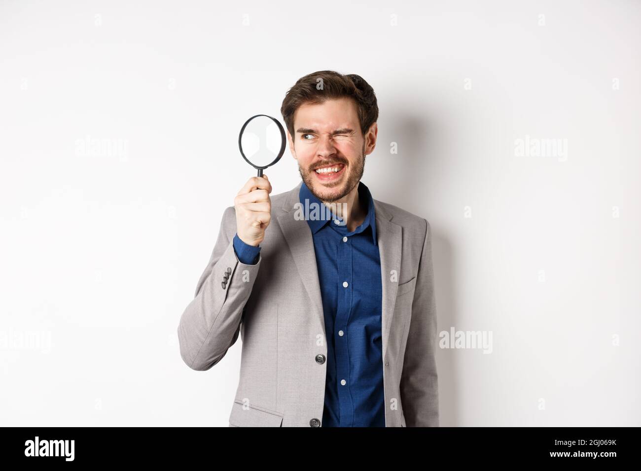 Funny guy in suit investigating or searching for something, looking ...