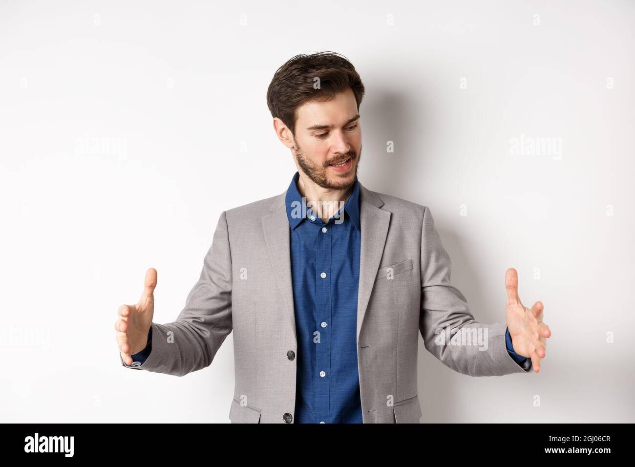 Excited handsome businessman showing long size thing, big object with ...