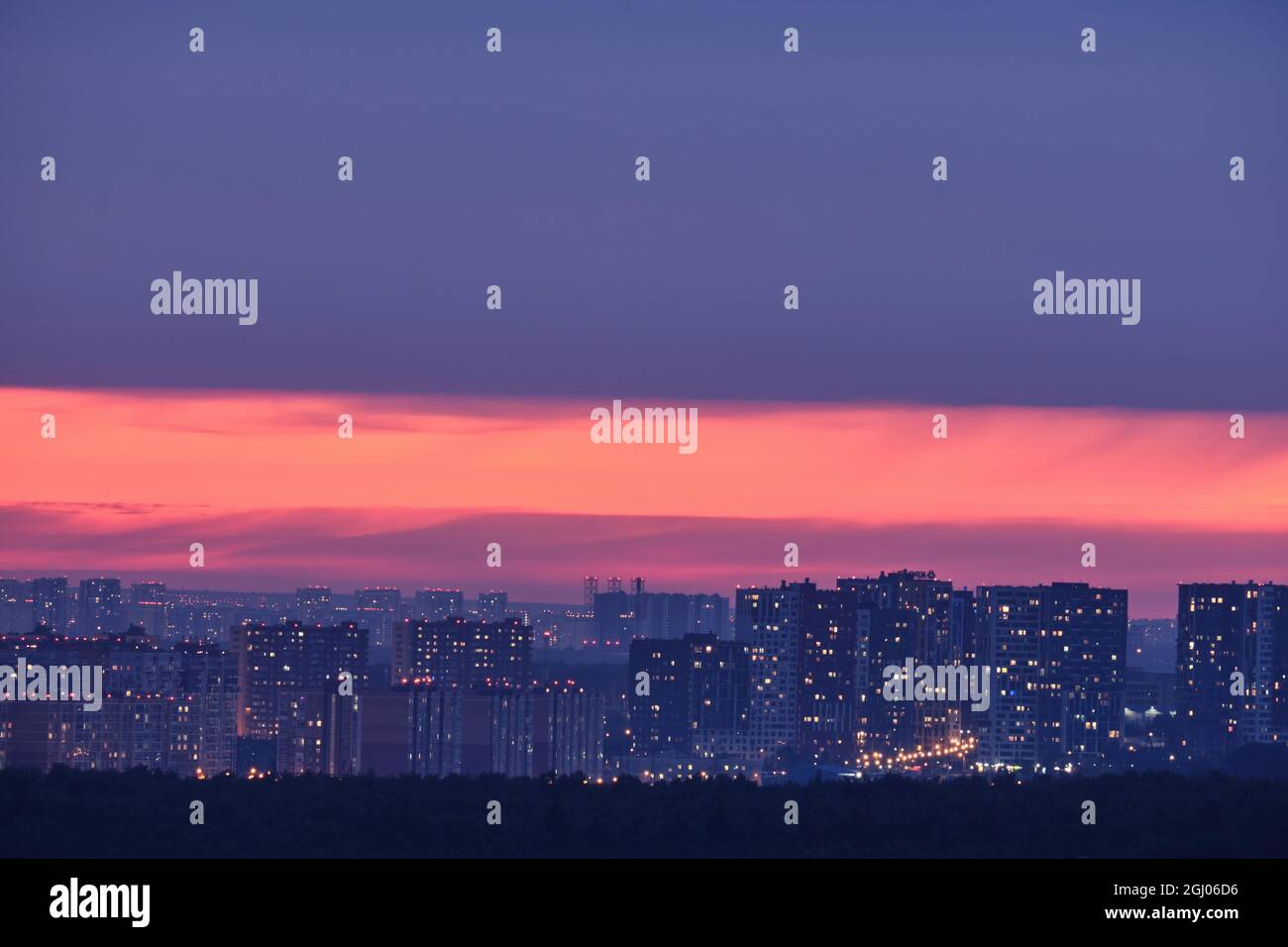 Night city lights at dusk sunset, red sky over houses Stock Photo - Alamy