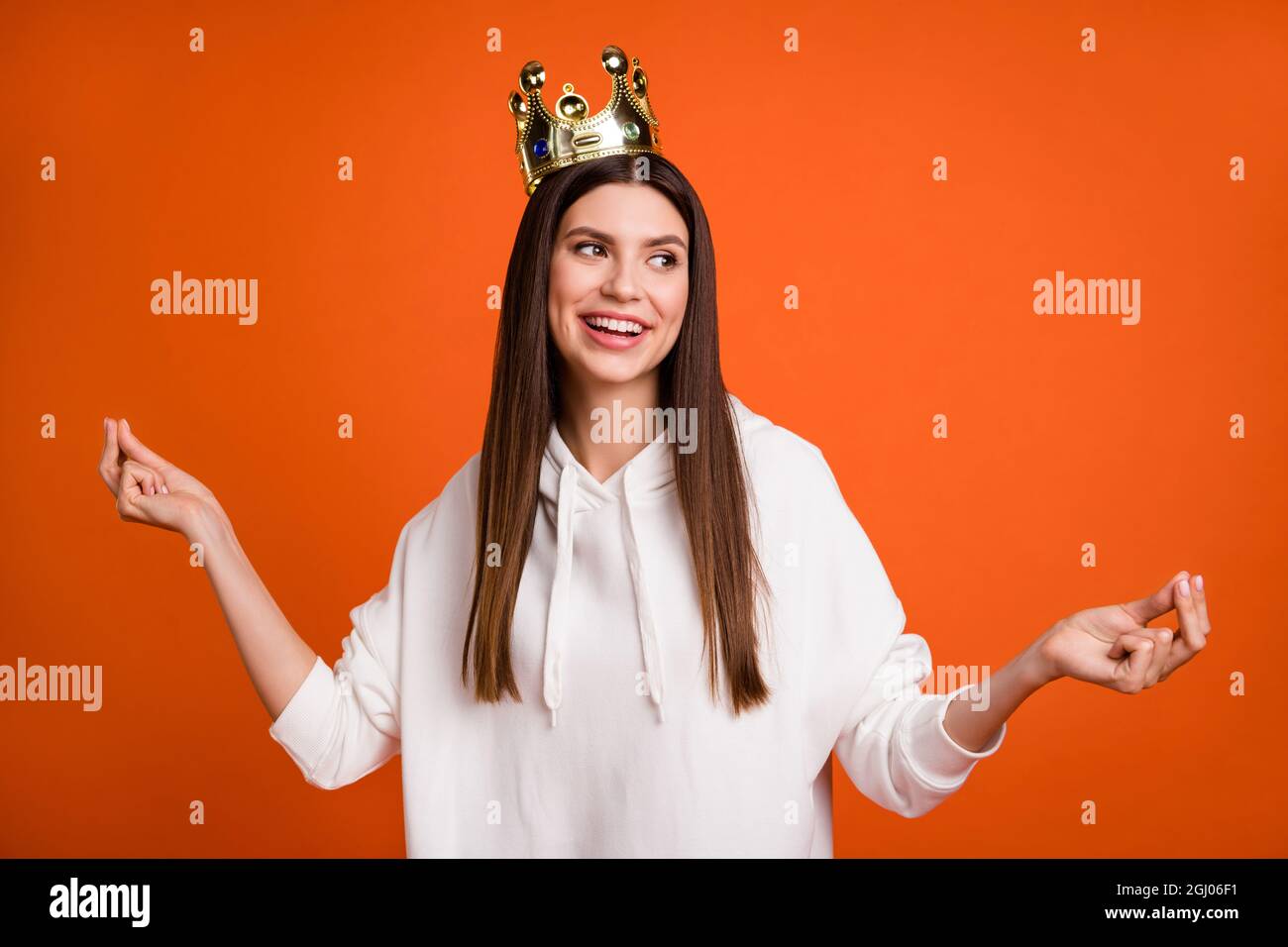 Portrait of attractive carefree cheerful girl wearing crown dancing ...