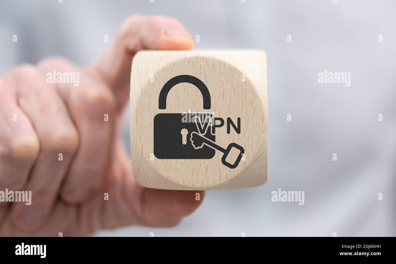 Hand holding a wooden cube with symbol of vpn concept Stock Photo - Alamy