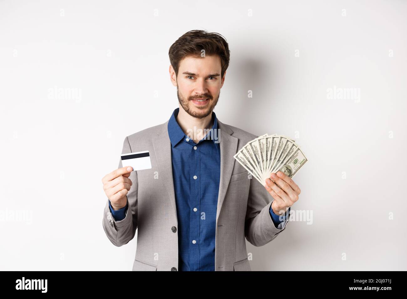 Rich smiling man in suit showing money and plastic credit card ...