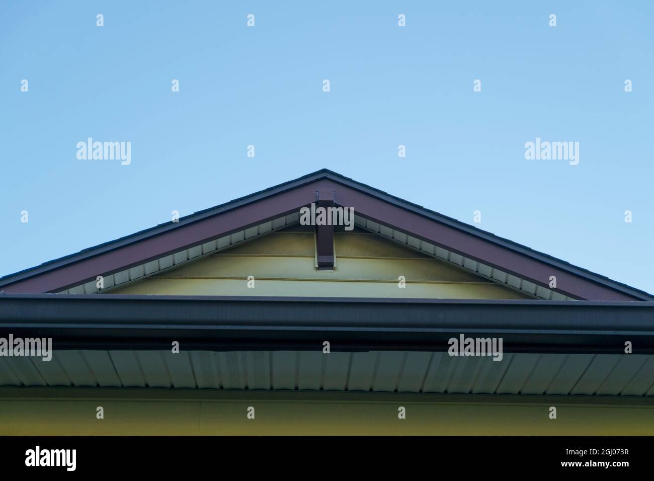 A roof eave, gable and gutter of a generic, typical old home, house. In ...