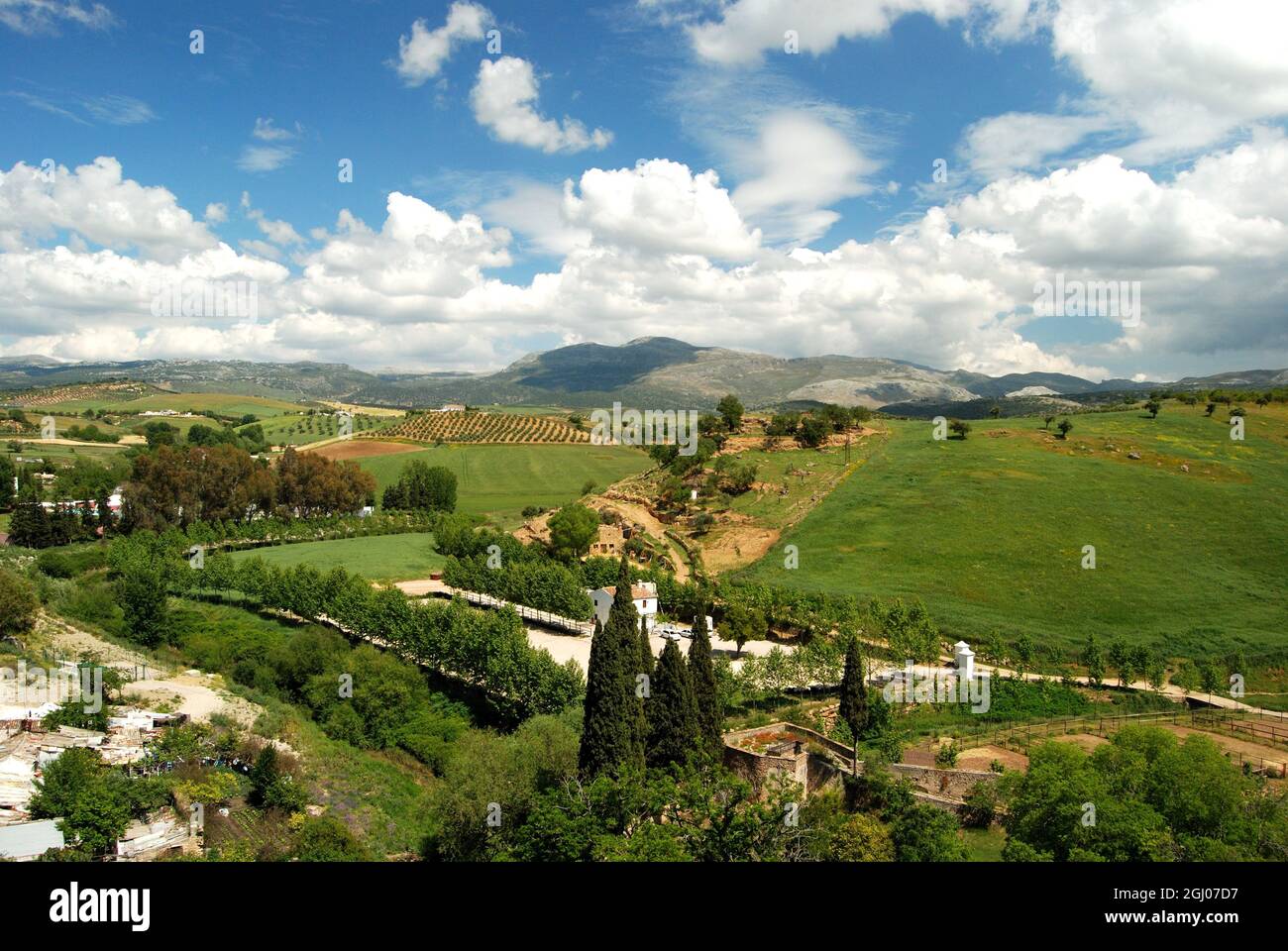 Elevated view across farmland and the countryside towards the mountains ...