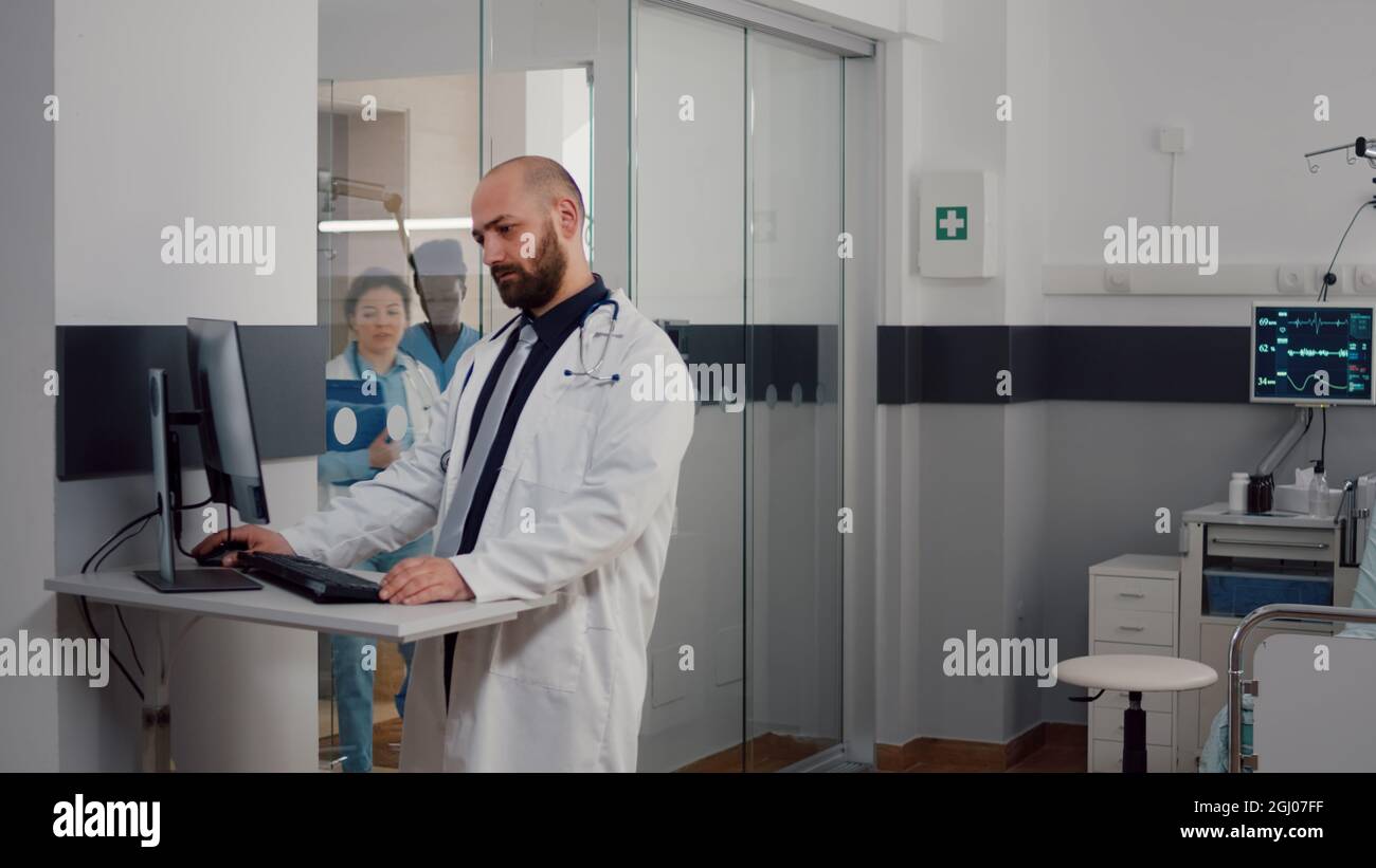 Doctor practitioner in uniform analyzing disease diagnosis typing ...