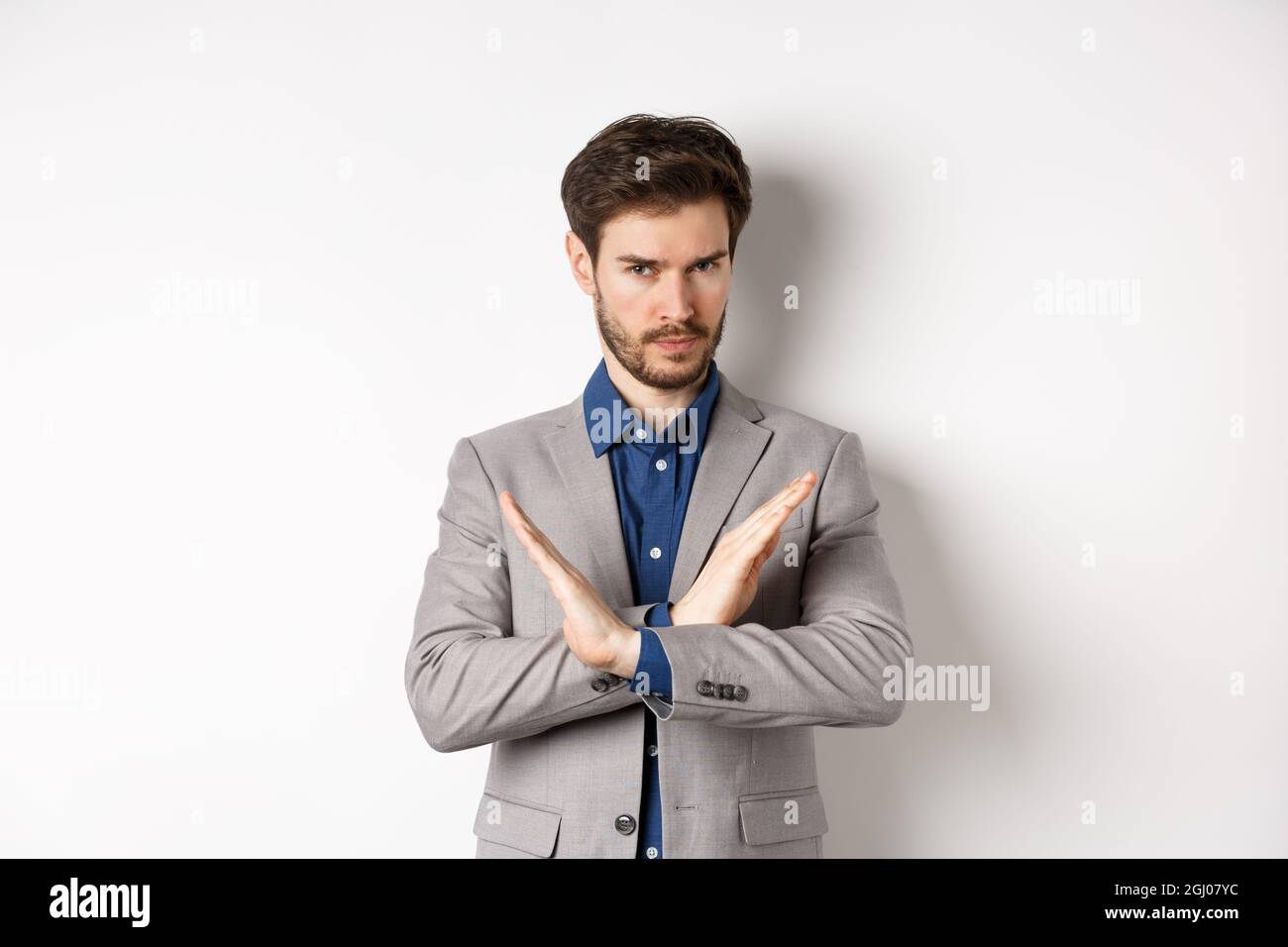 Serious business man making cross and says no, looking determined ...