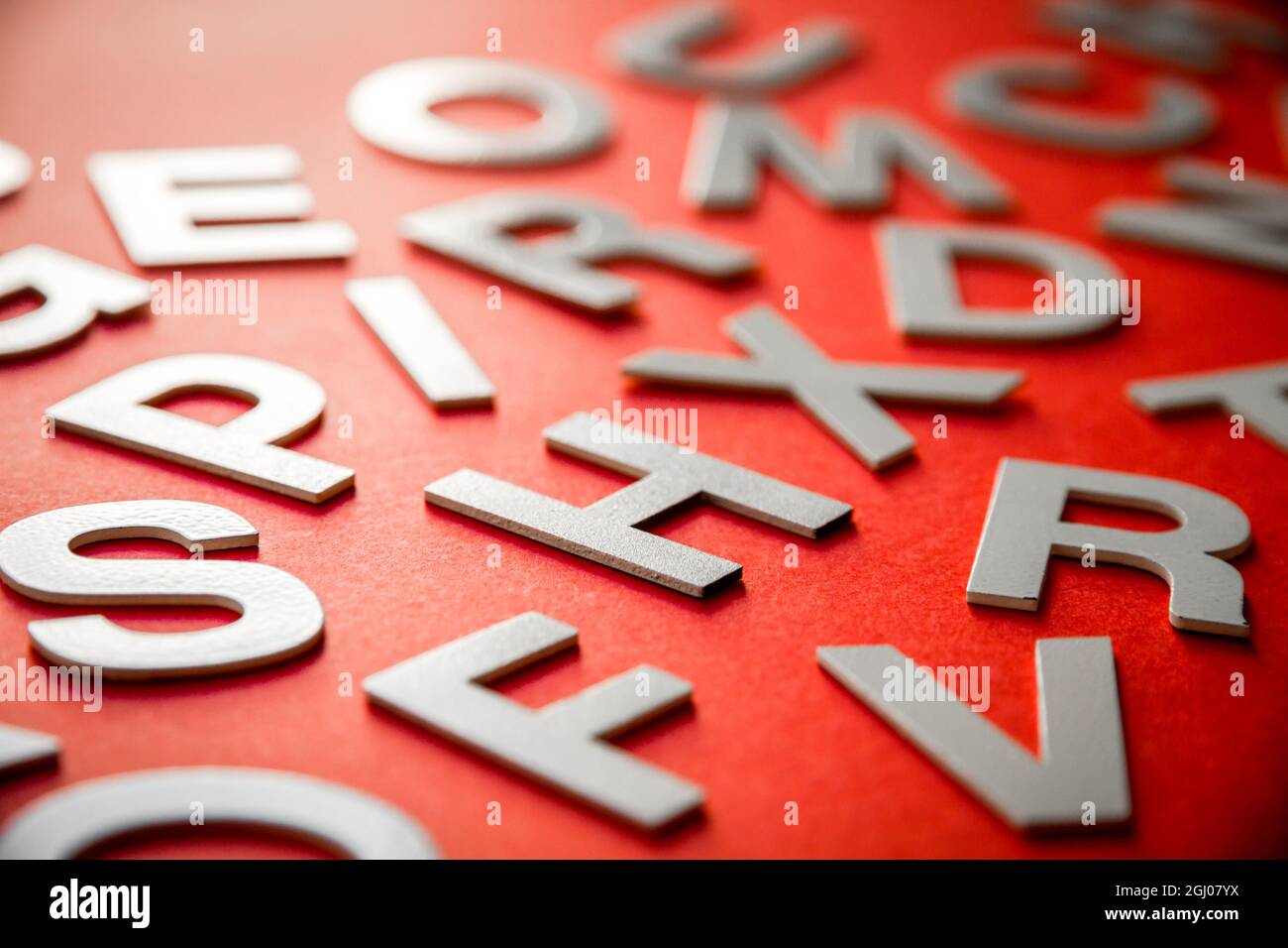 Mixed solid letters pile close up view photo. Education concept on red ...
