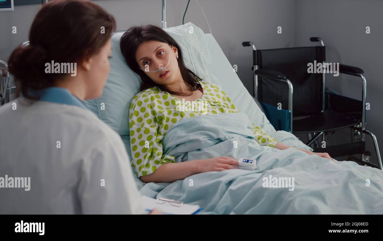 Doctor practitioner writing sickness symptom on clipboard checking ...