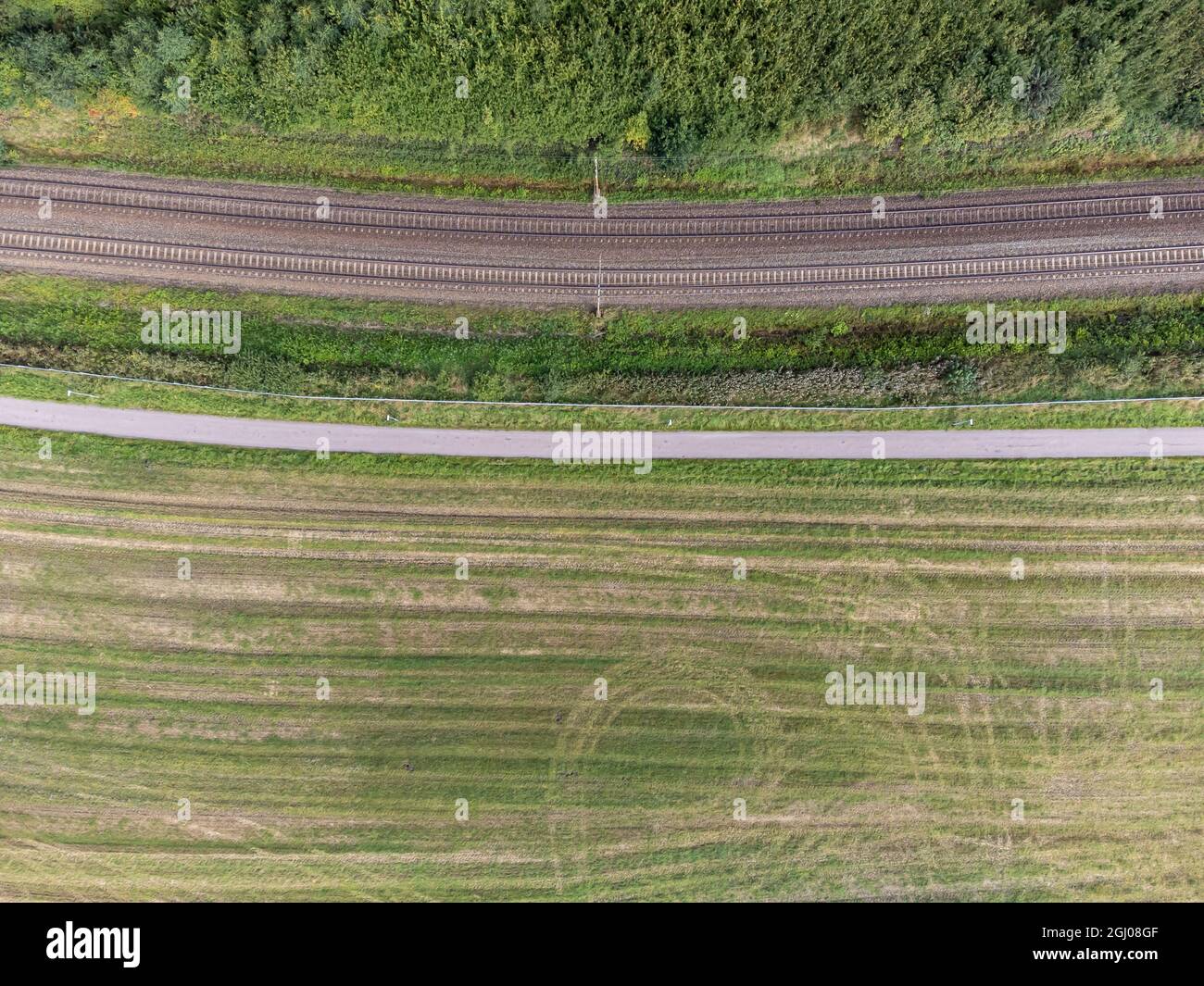 Leading lines, agriculture field, path and railway track Stock Photo ...