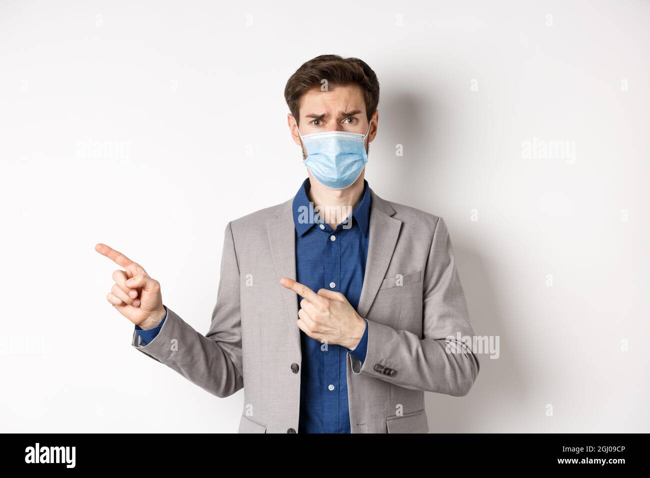 Covid-19, pandemic and business concept. Upset man in medical mask and ...