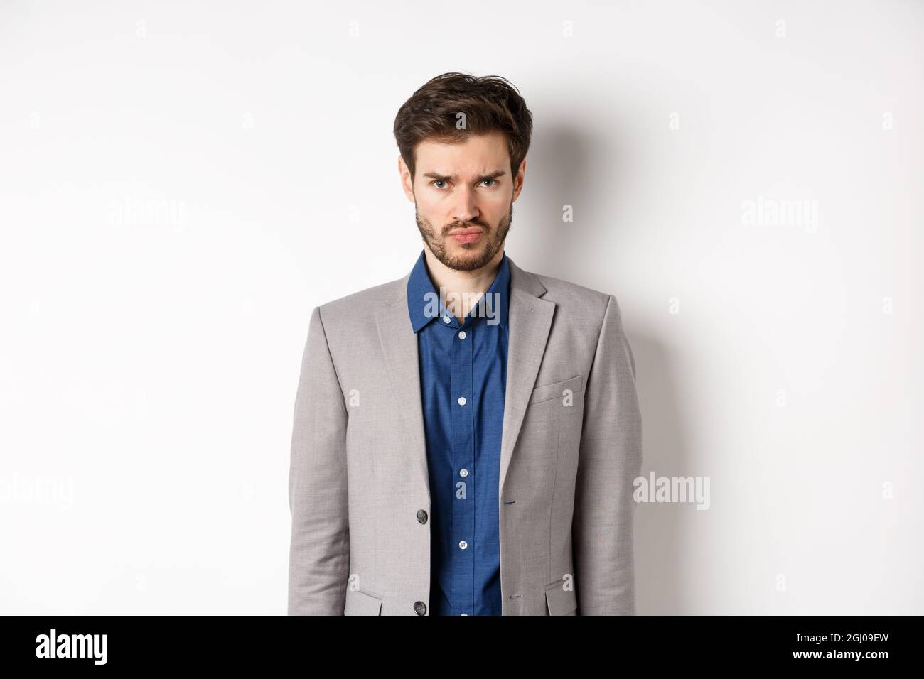 Sad offended guy sulking, wearing business suit, feel something unfair ...