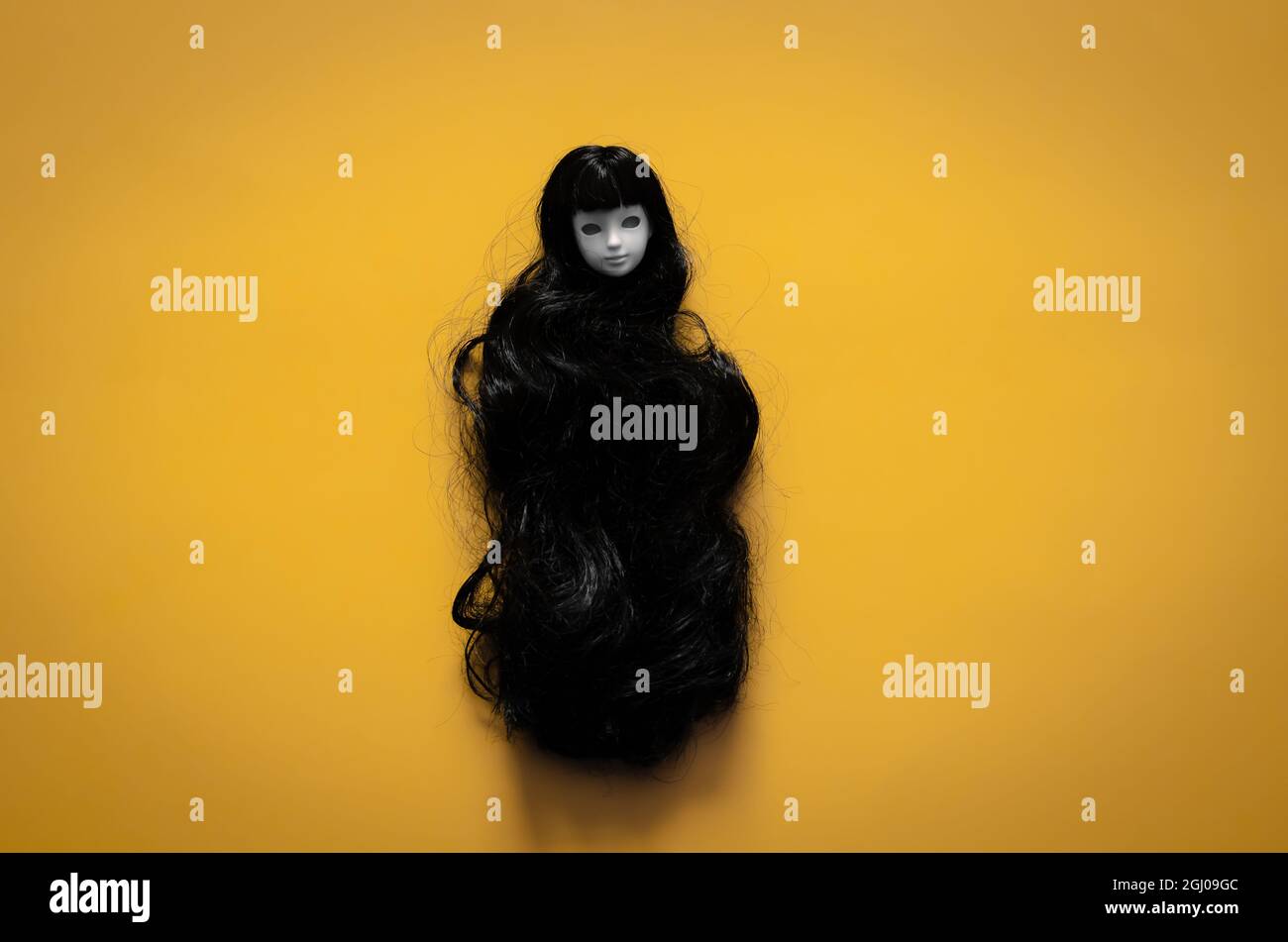 Long hair smiling female ghost doll on yellow background. Minimal ...