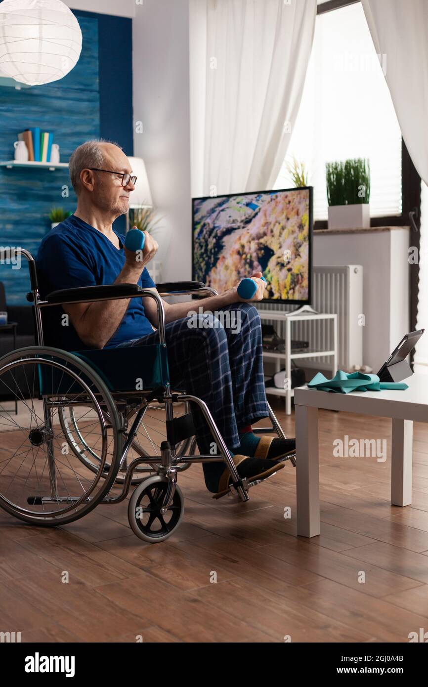 Invalid pensioner in wheelchair training body muscles persistence using ...