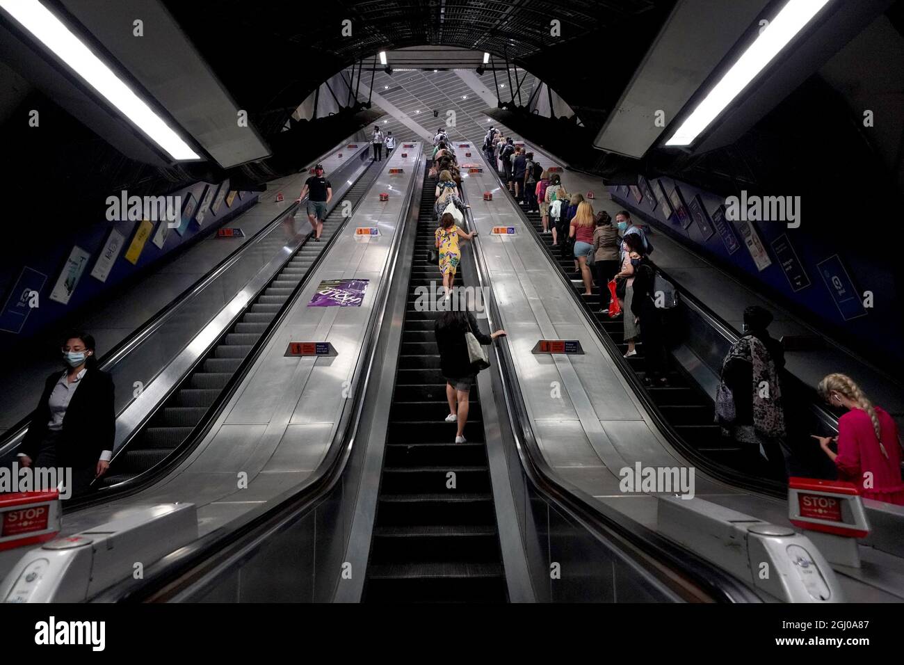 Passengers use escalators to leave London Bridge underground station ...