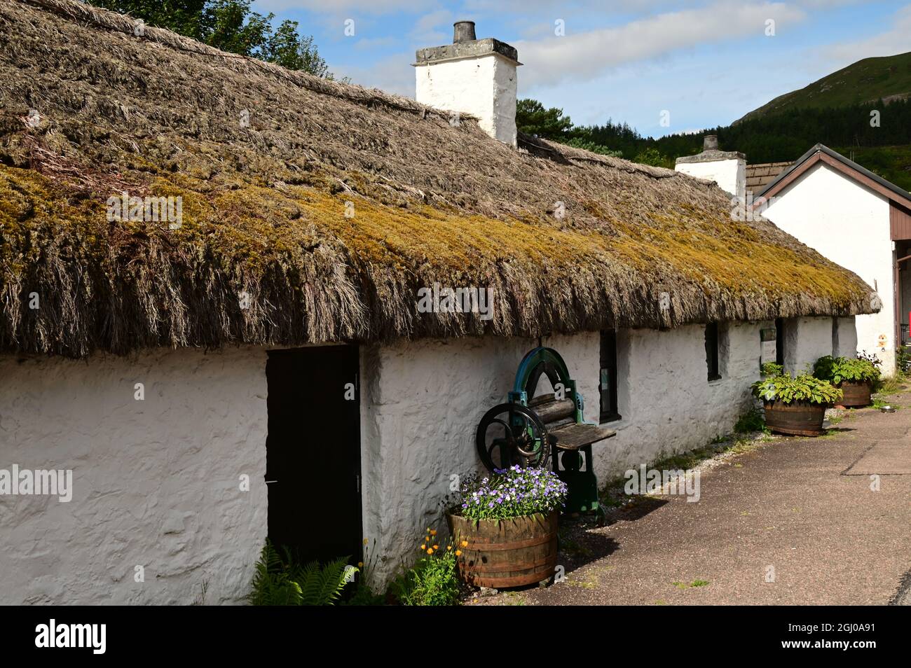 An exterior view of a thatched roof building in the Scottish highland ...