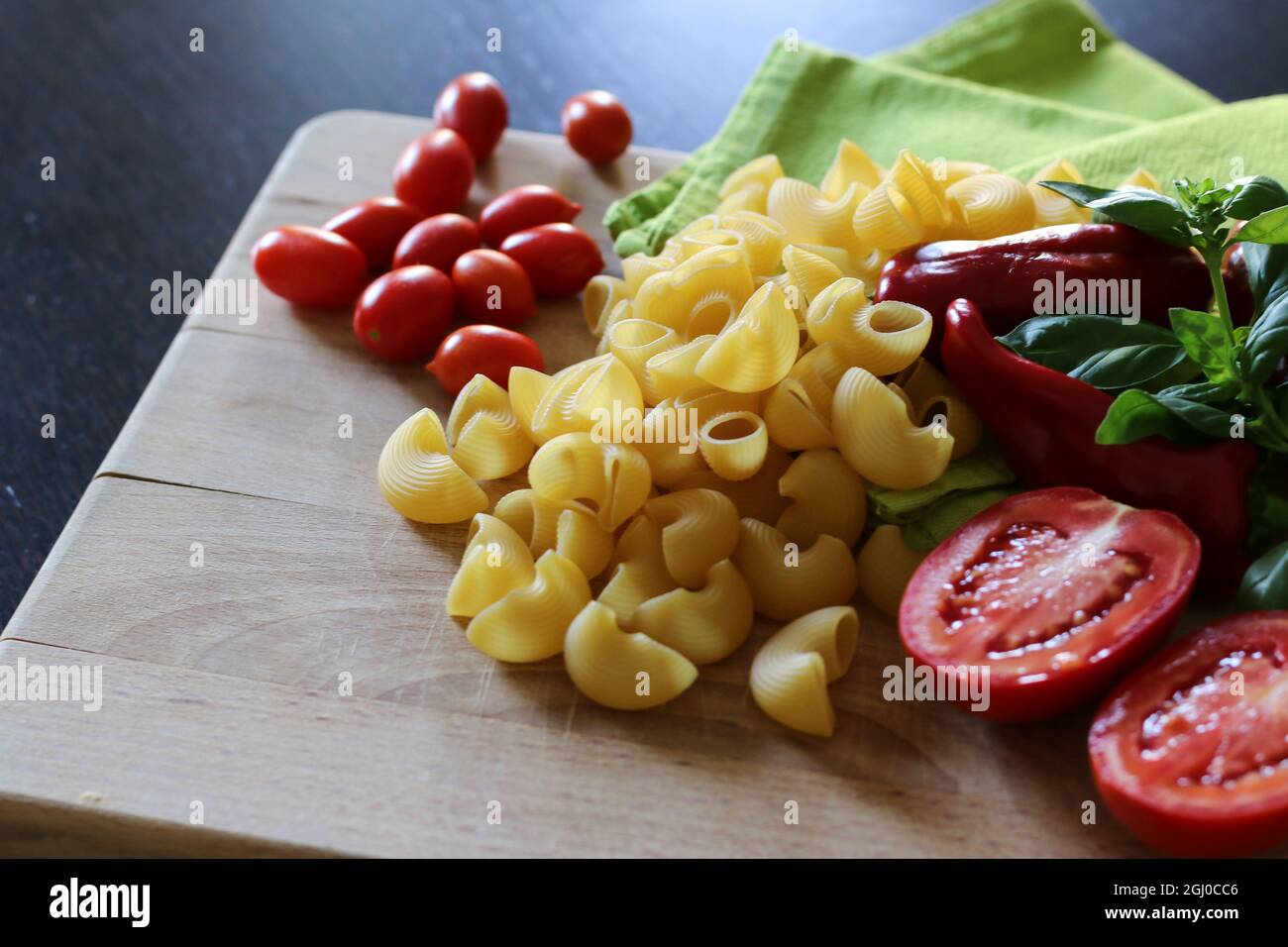 Fresh ingredients of making a conchiglie pasta in the kitchen, cherry ...