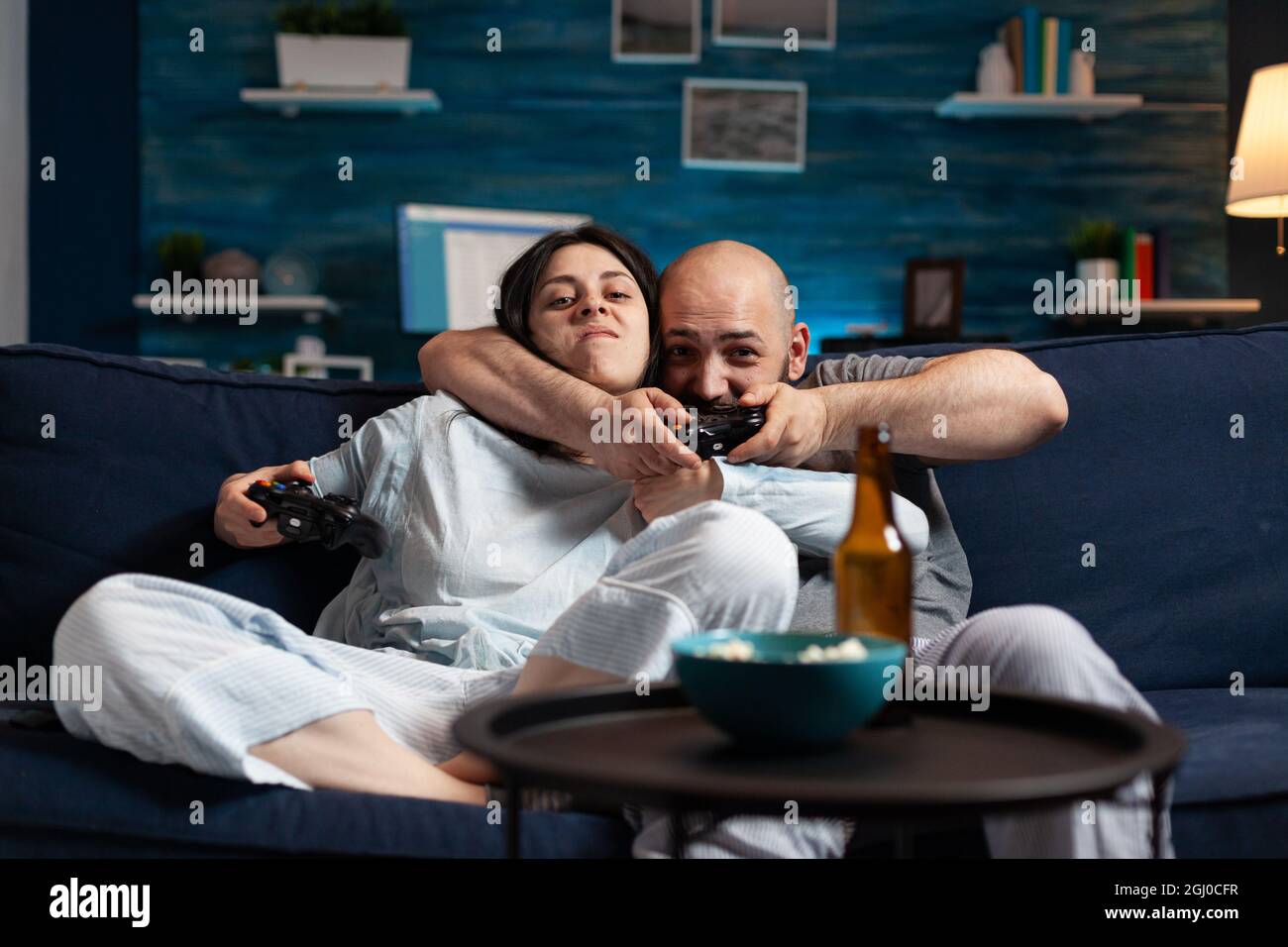 Determinated enthusiastic couple winning video games, hugged each other ...