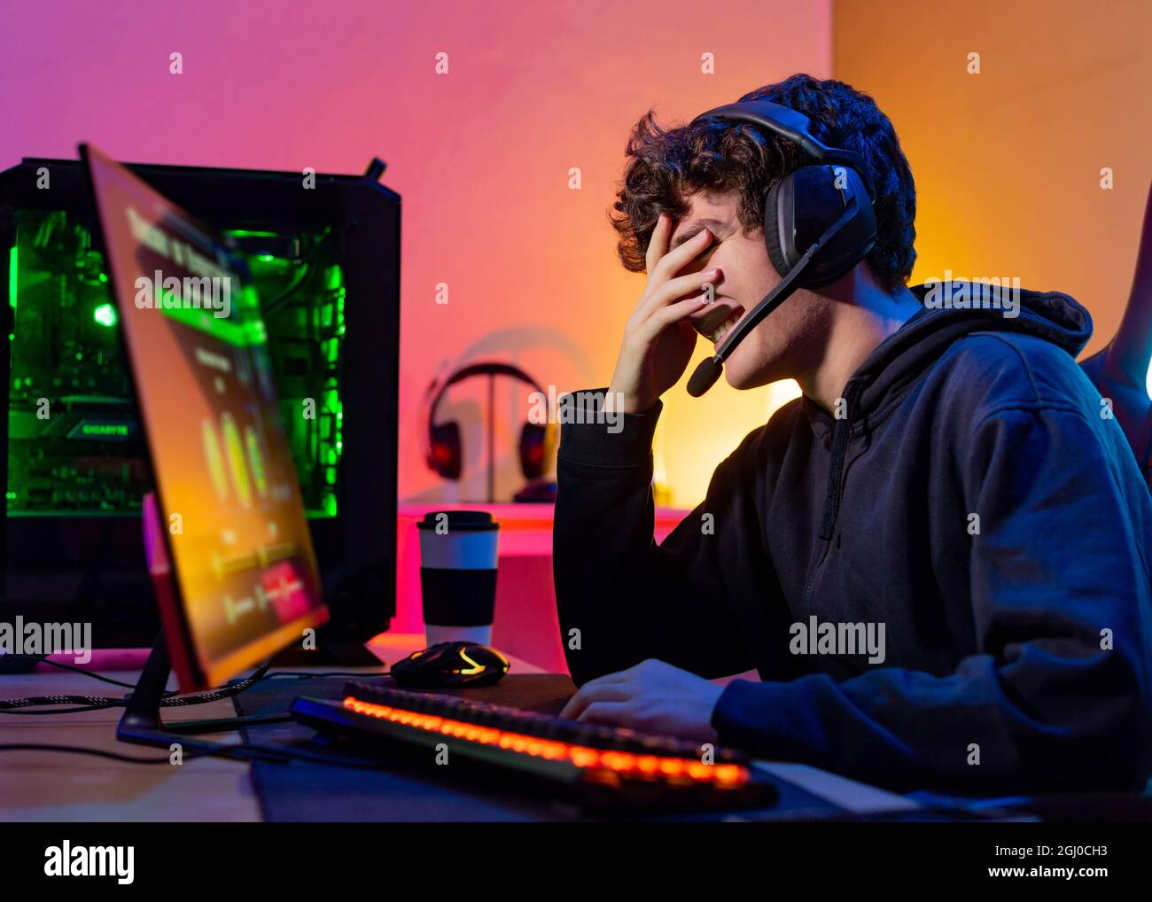 Laughing man playing video game on computer Stock Photo - Alamy