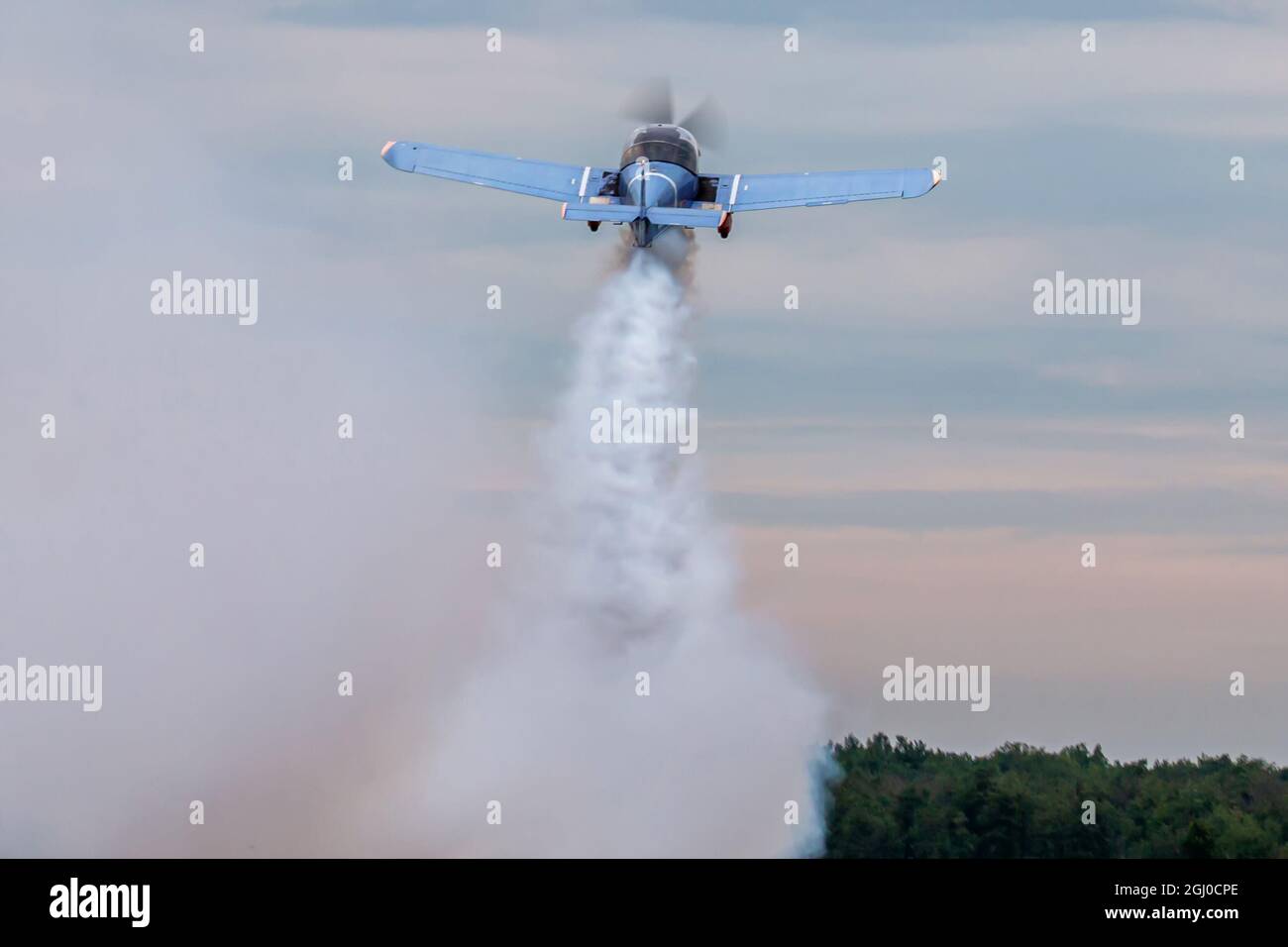 Takeoff of a sports airplane with smoke Stock Photo - Alamy