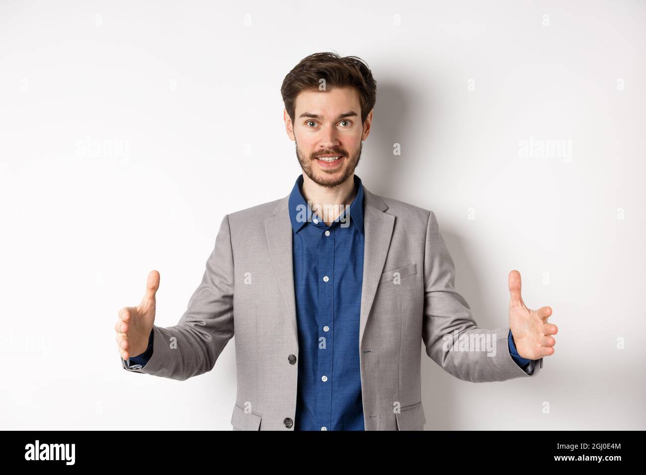 Excited handsome businessman showing long size thing, big object with ...