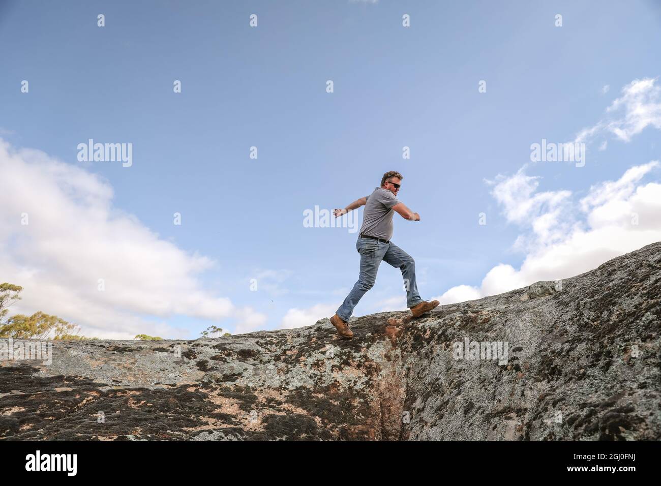 Man running and jumping on rocks in nature Stock Photo - Alamy